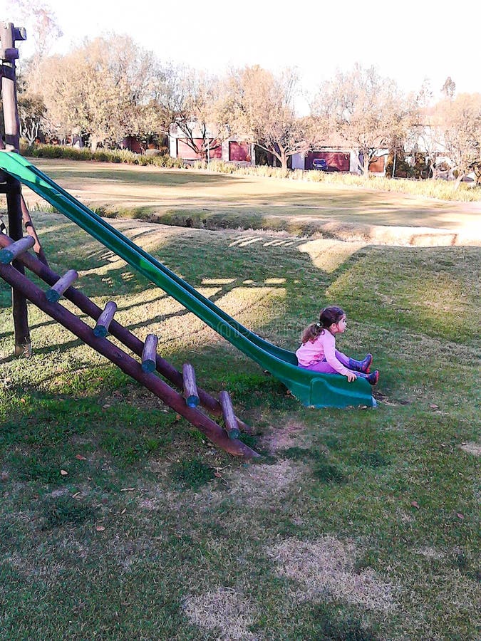 Girl Going Down Slide at a Park Editorial Photo - Image of amusement ...