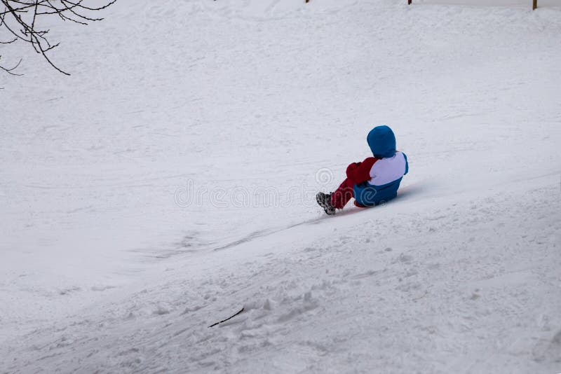 The Child Slides Down the Snow Slide. Stock Photo - Image of season ...