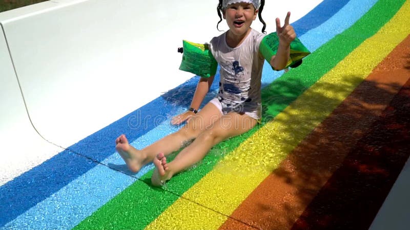 A Child Slides Down a Water Slide. Stock Footage - Video of girl, happy ...