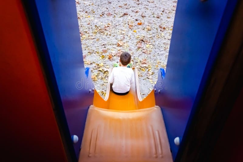 Child Sliding Down a Slide, Seen from the Back from Above Stock Image ...