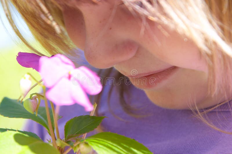 Child smelling flowers stock image. Image of youth, girl - 231269