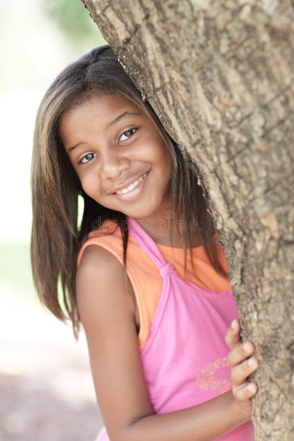 Child Smiling from Behind the Tree Stock Image - Image of stylish ...