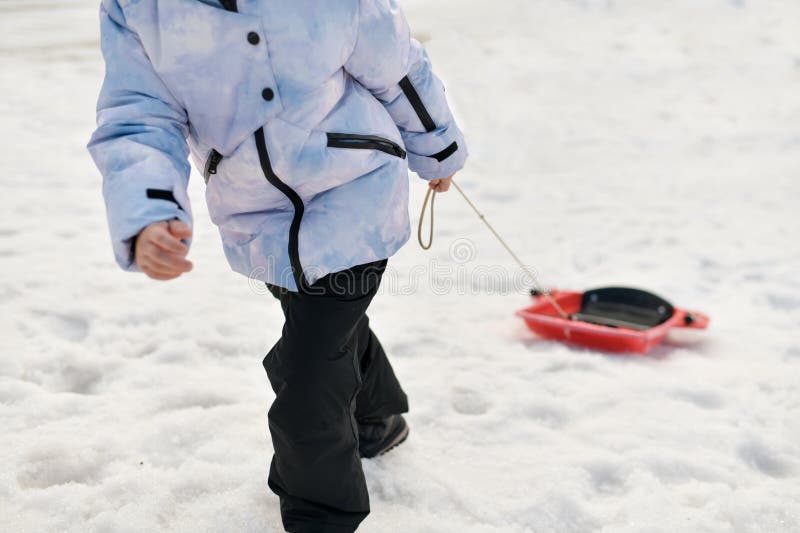 A Child with Snow Bob Sledding in the Snow Stock Image - Image of ...