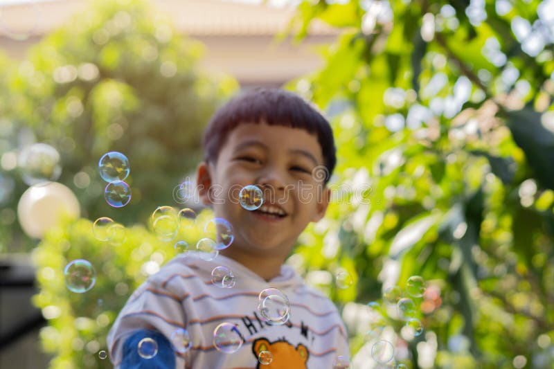 Child and Soap Bubbles Concept. Happy Child Blowing Bubbles in Park Stock Image - Image of ...
