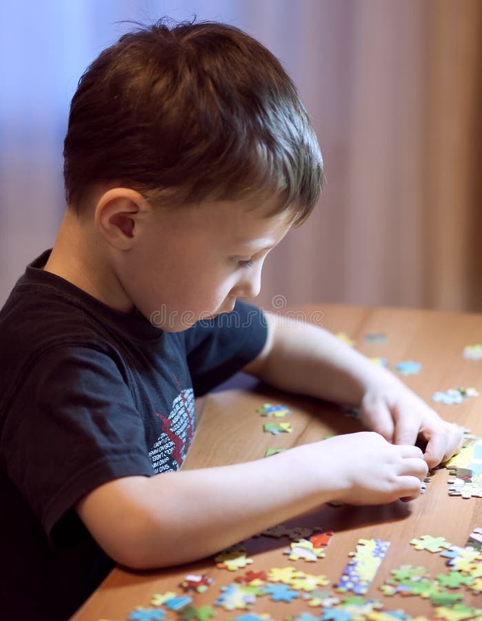 Child Solving a Puzzle - Education Stock Image - Image of environmental ...