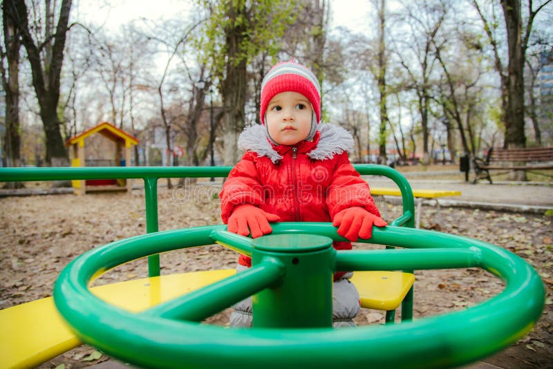 The Child is Spinning on a Swing in the Playground in the Park Stock ...