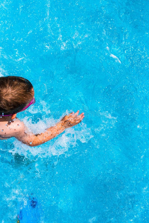 Child Splashing in the Cool Water of a Pool in Summer Stock Photo ...