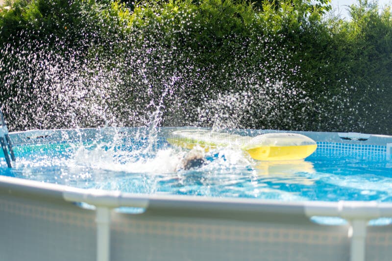 A Child Splashing in Their Own Pool in the Garden Stock Image - Image ...