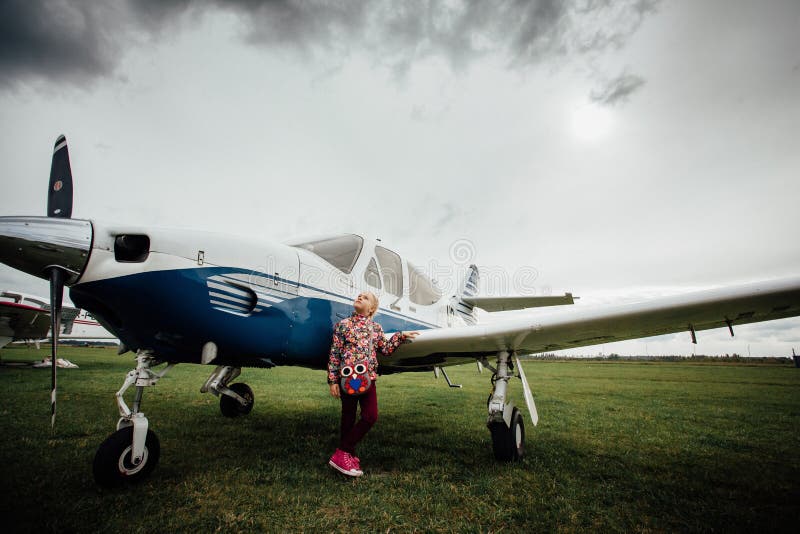 The Child is Standing, Preparing To Fly on an American Plane on an ...