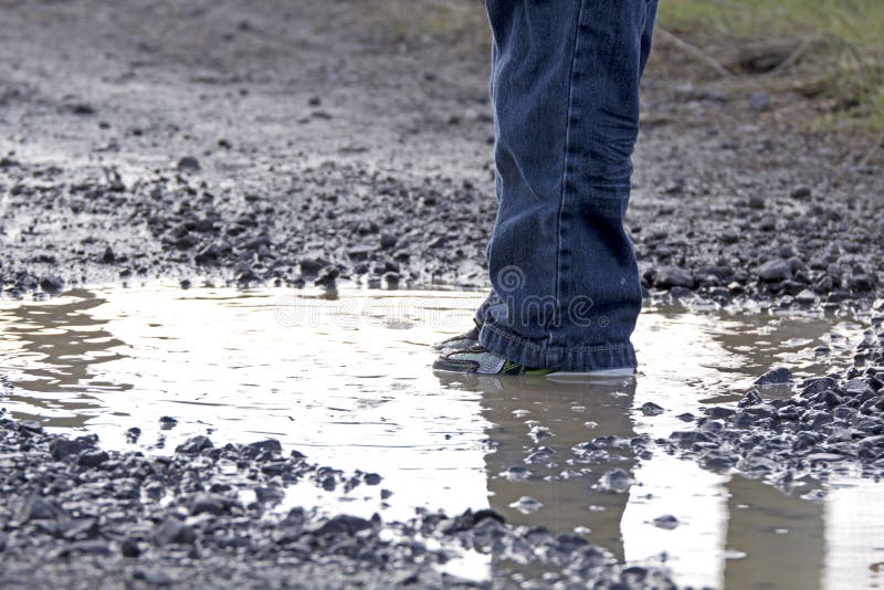 Child Standing Still in Puddle Stock Image - Image of stand, jeans ...