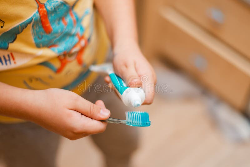 A Child Stands with a Toothbrush and Toothpaste and is about To Brush ...