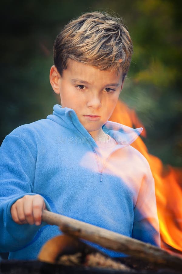 Child staring at campfire stock photo. Image of orange - 27846658