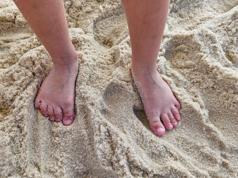 Child stepping on the sand stock image. Image of playful - 364428303