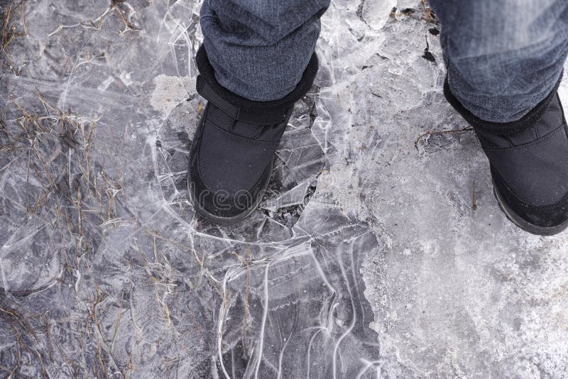 Child Steps on Frozen Puddle with Thin Ice Stock Photo - Image of ...