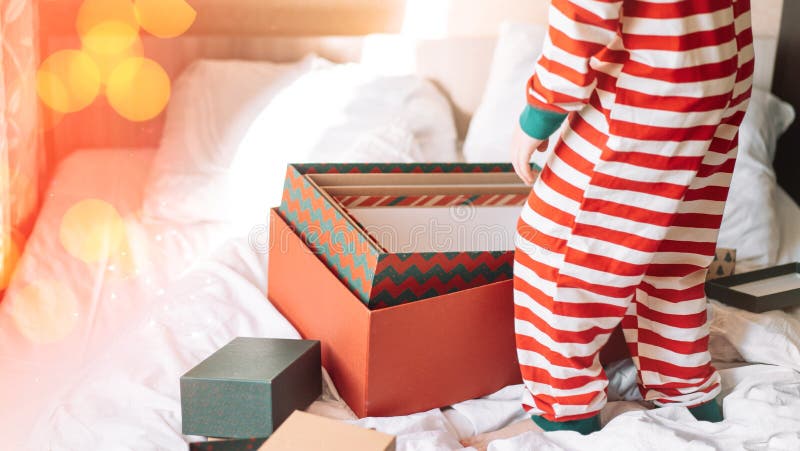 Child in Striped Pajamas Standing Next To Open Boxes Stock Image ...