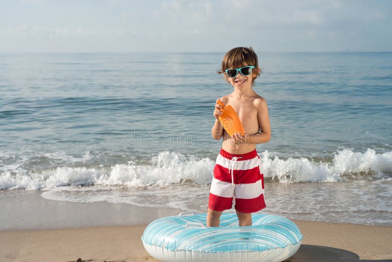 Child with Sun Protection Spray in the Beach Stock Image - Image of ...