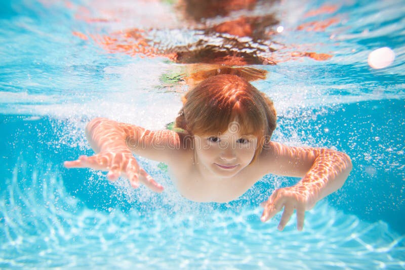 Child Swim and Dive Underwater in the Swimming Pool. Stock Photo ...