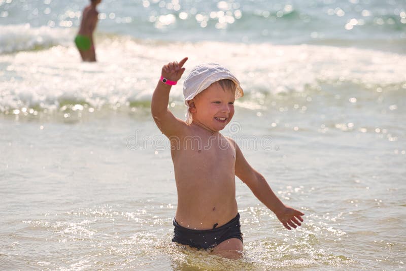Child Swims in the Sea Waves on the Beach Stock Image - Image of child ...