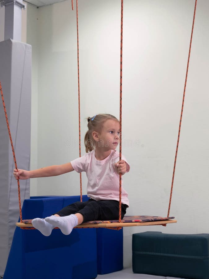 Child on Swing during Sensory Integration Session. Stock Photo - Image ...