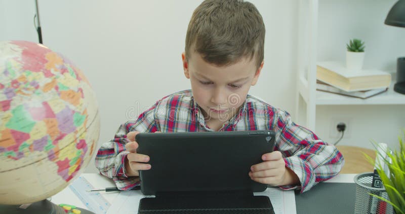 A Child with a Tablet. the Boy Uses a Tablet for Distance Education Via ...