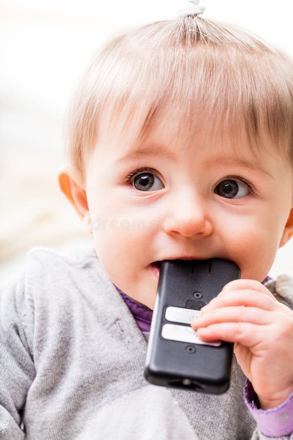 Child Tasting a Remote Control To Check Stock Photo - Image of ...