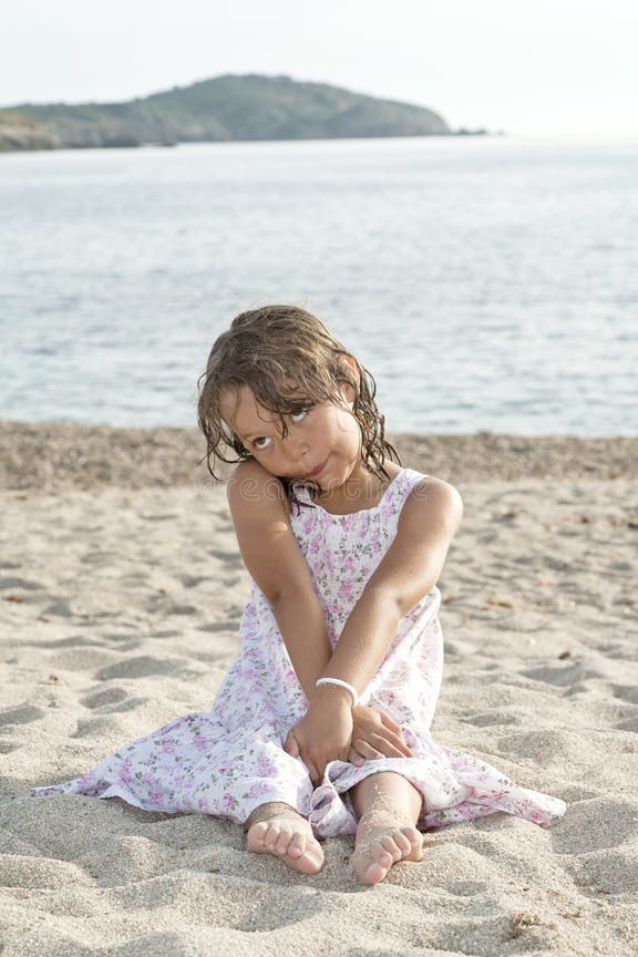 Child thinking on the sand stock image. Image of vacation - 26154283