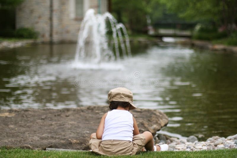 Child throwing rocks stock photo. Image of pretty, pond - 7317212