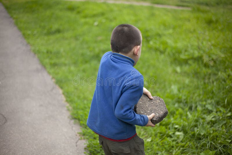 The Child Throws a Stone. Aggressive Boy Stock Image - Image of child ...