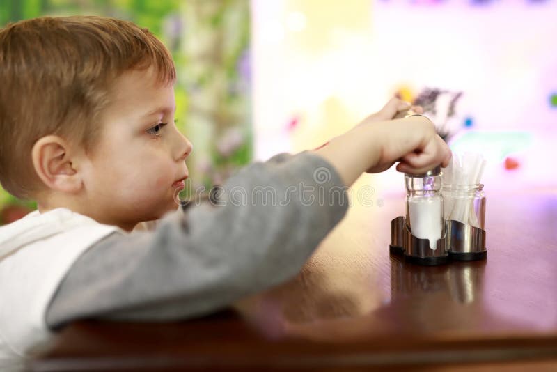 Child touching salt shaker stock photo. Image of flavor - 162936434