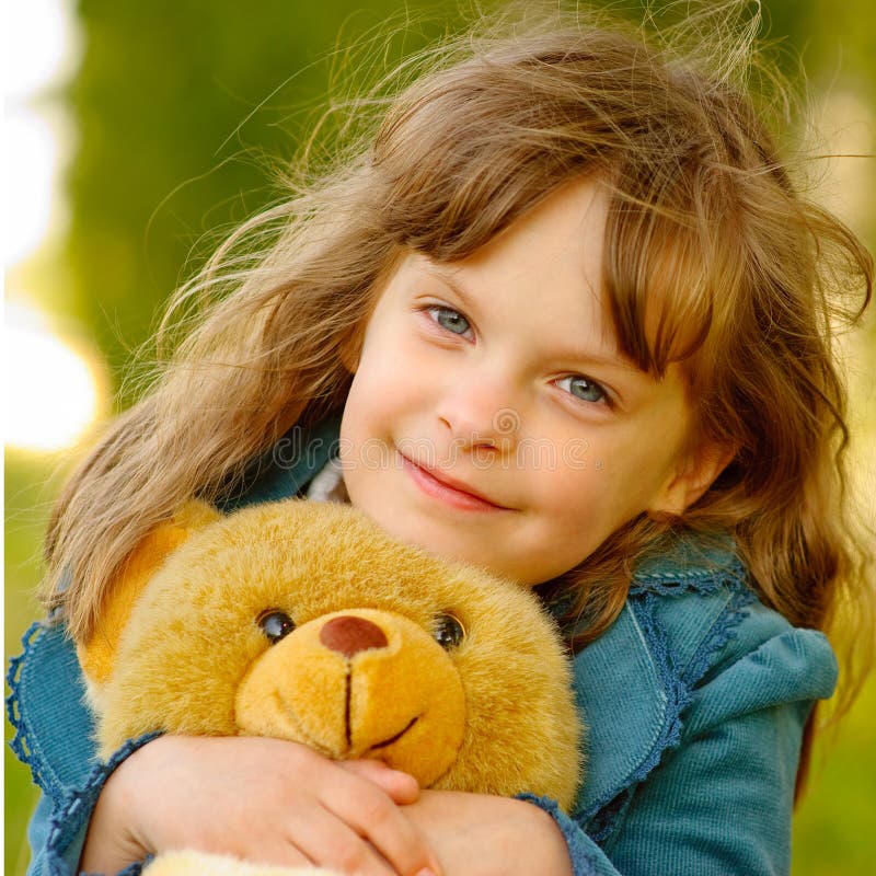 Child with toy bear cub stock image. Image of brown, embraces - 6056477