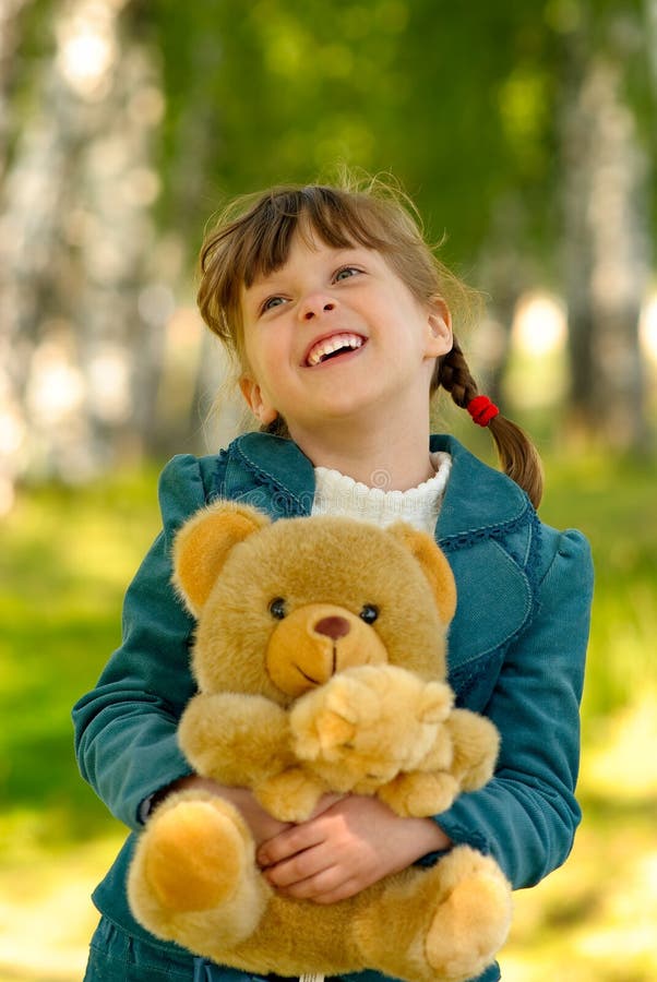 Child with toy bear cub stock image. Image of brown, embraces - 6056477