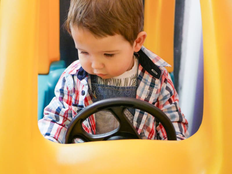 Child on a Toy Car. the Car is Yellow. Child 0-1 Year Old Stock Image ...