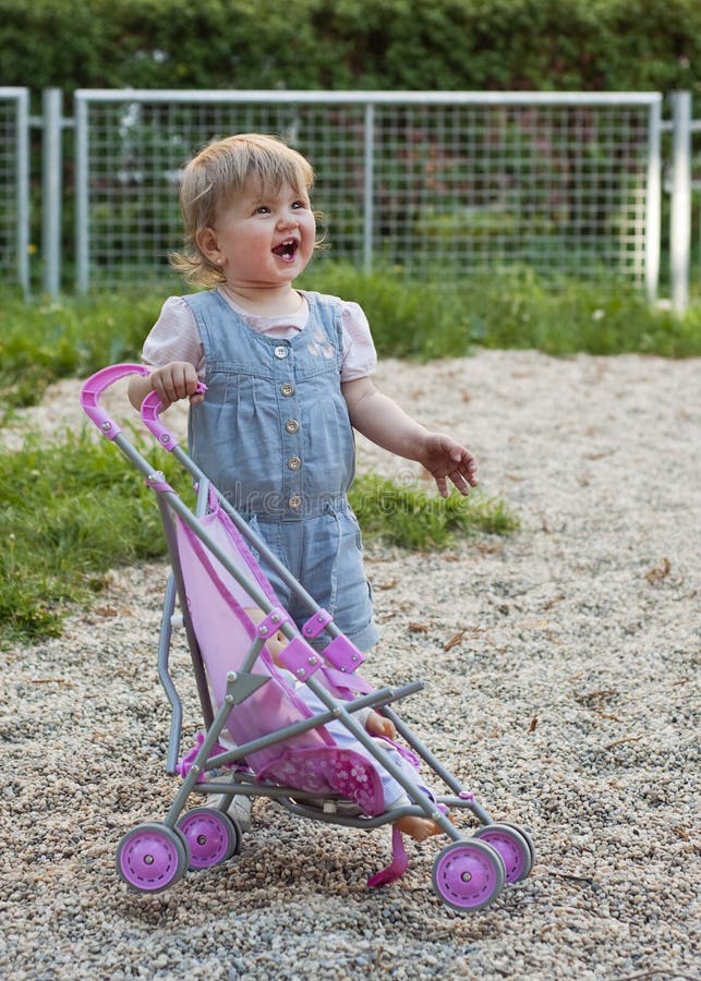 Child with a toy pram stock image. Image of pushchair - 24744191