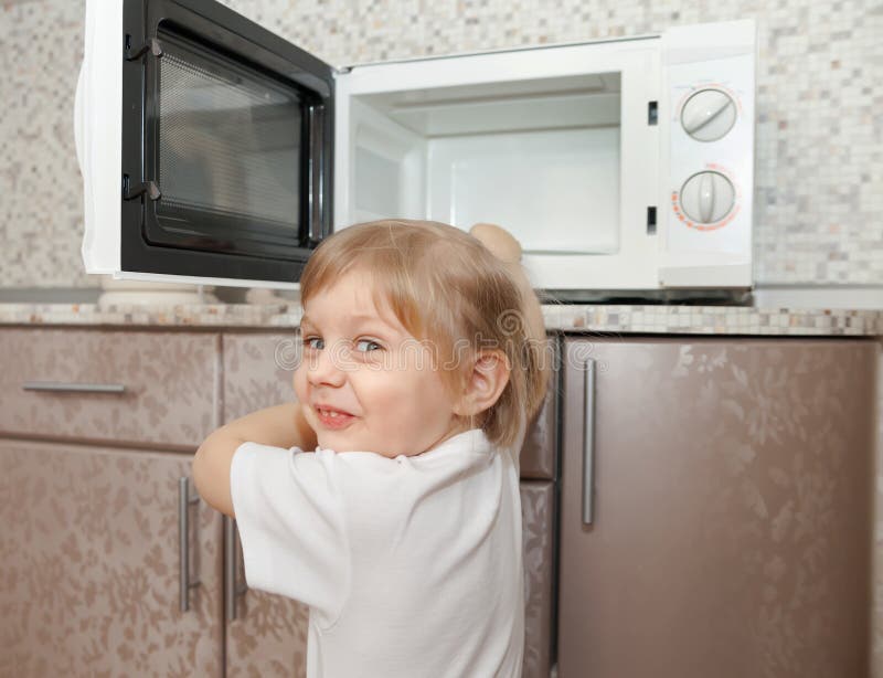 Child Trying To Turn on Microwave Stock Photo - Image of childhood ...