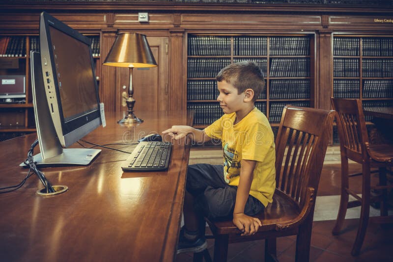 Child Uses Computer in the Suggestive New York Public Library Editorial ...