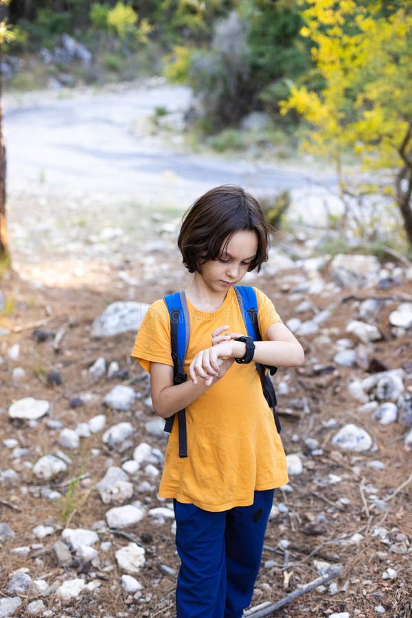The Child Uses an Electronic Watch while Hiking Stock Photo - Image of ...