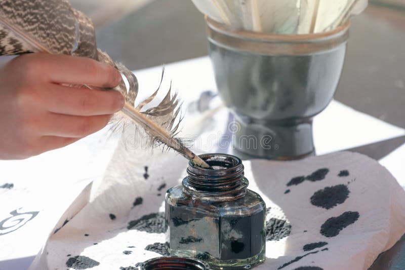 Child Using Feather Quill and Ink Jar for Writing on Paper Outdoors ...