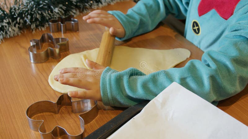 Child Using Gingerbread Man Cookie Cutter and Making Christmas Cookies ...