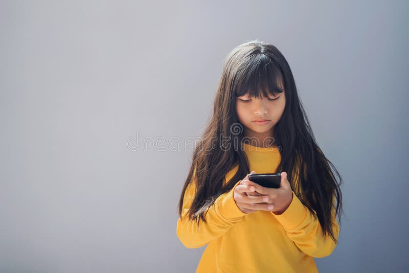 Child using mobile on blue stock photo. Image of internet - 169635182
