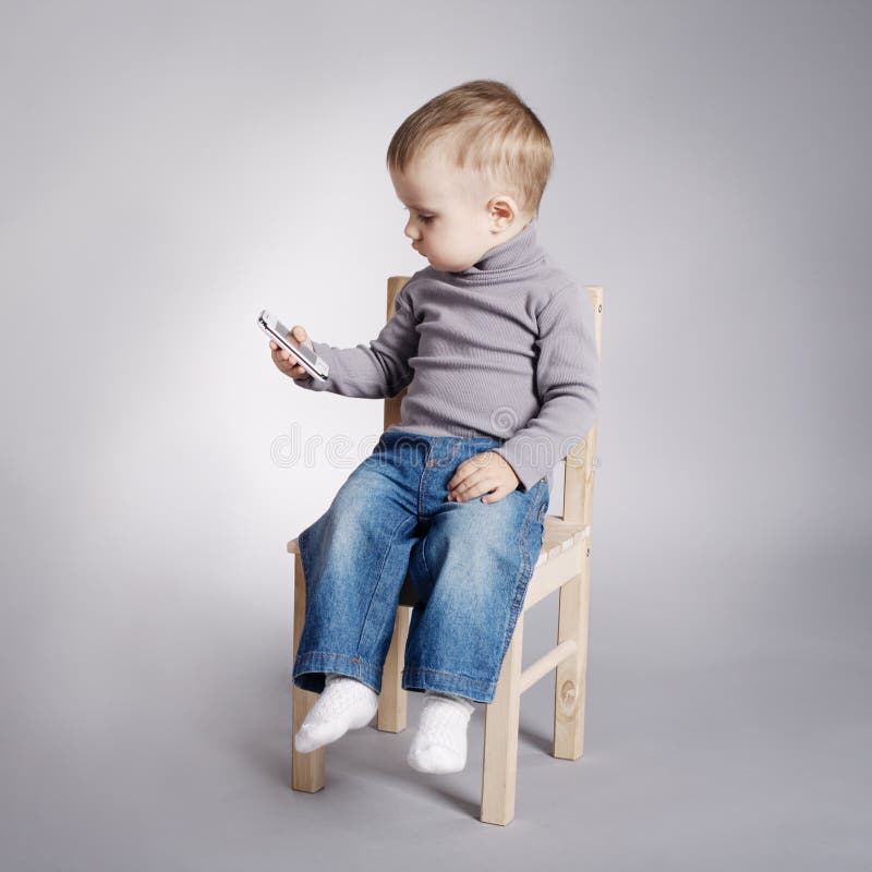 Child using a mobile phone stock image. Image of grey - 38183723