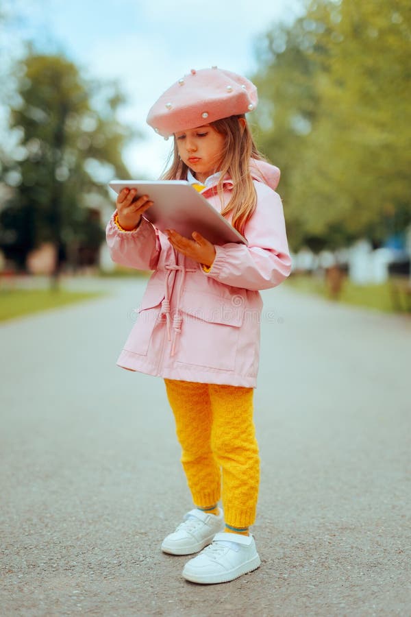 Child Using a Pc Tablet Despite Being Outdoors in the Park Stock Photo ...