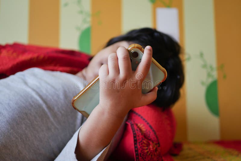 Child Using Smart Phone on Bed Stock Image - Image of browsing, table ...