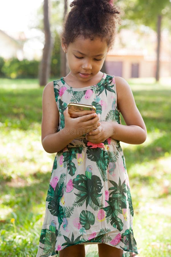 Child Using Smartphone at Park Stock Photo - Image of playing, happy ...