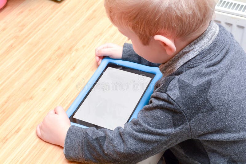 Child Using a Tablet Computer To Learn and Play Games, Model is Young ...