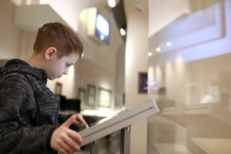 Child Using Touch Screen in Entertainment Center Stock Image - Image of ...
