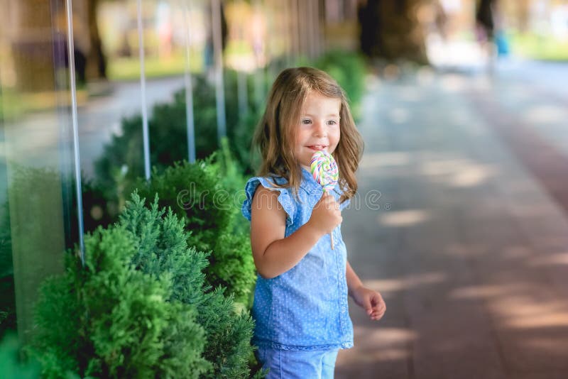 Child for a Walk in the Park with Candy in Hand Stock Image - Image of ...