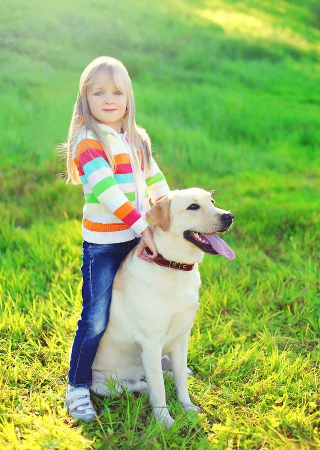 Child Walking with Labrador Retriever Dog on Grass Stock Image - Image ...