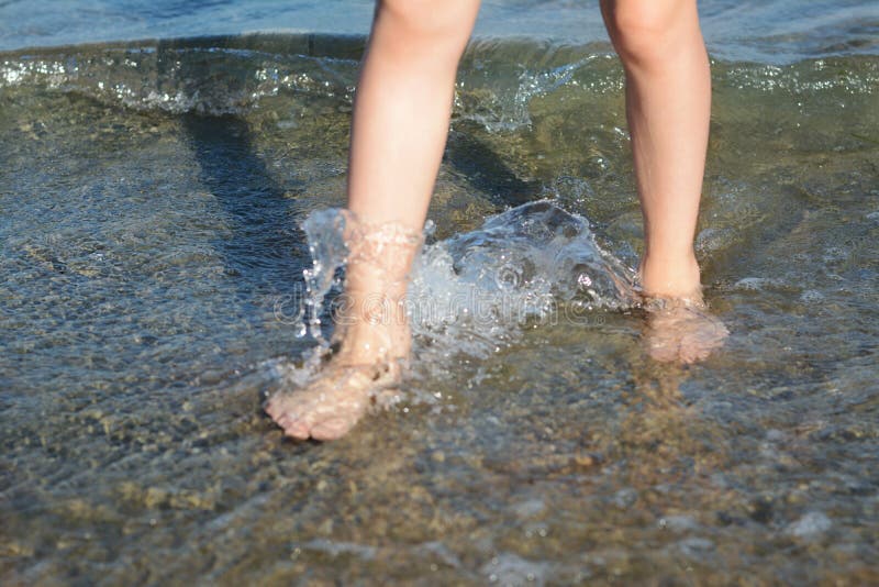Child Walking through Water on Seashore, Closeup Stock Image - Image of ...