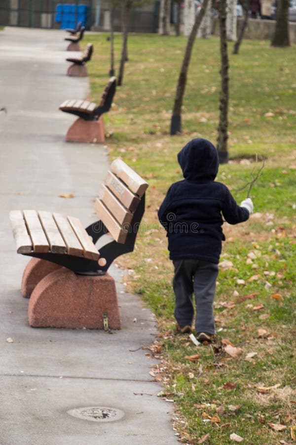 Child Walking by the Wooden Park Bench at a Park Stock Photo - Image of ...