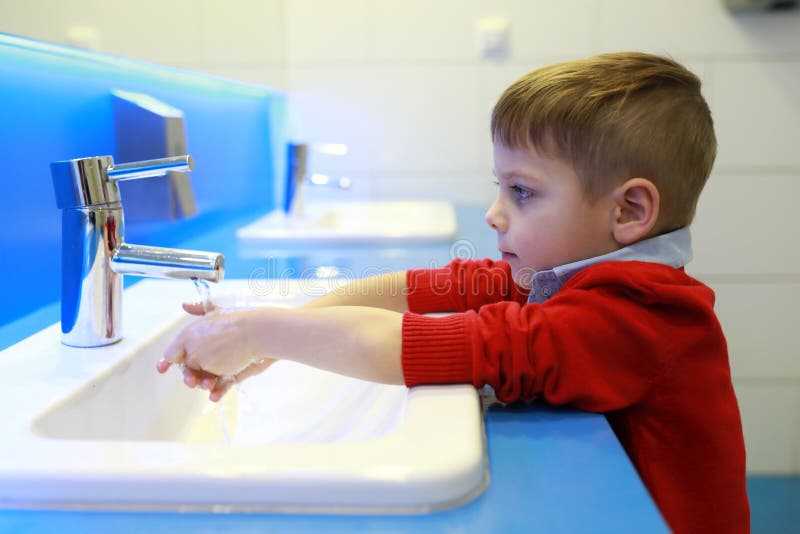 Boy washes his hands stock image. Image of beautiful - 164667443